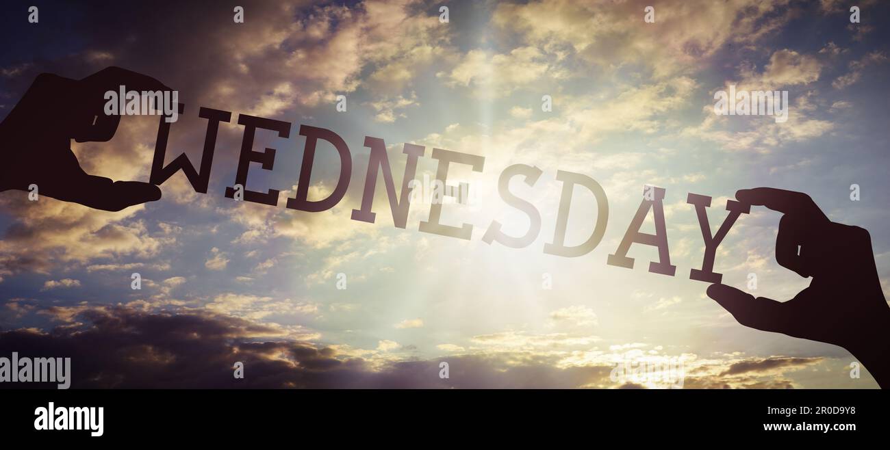 Wednesday - human hands holding black silhouette word Stock Photo - Alamy