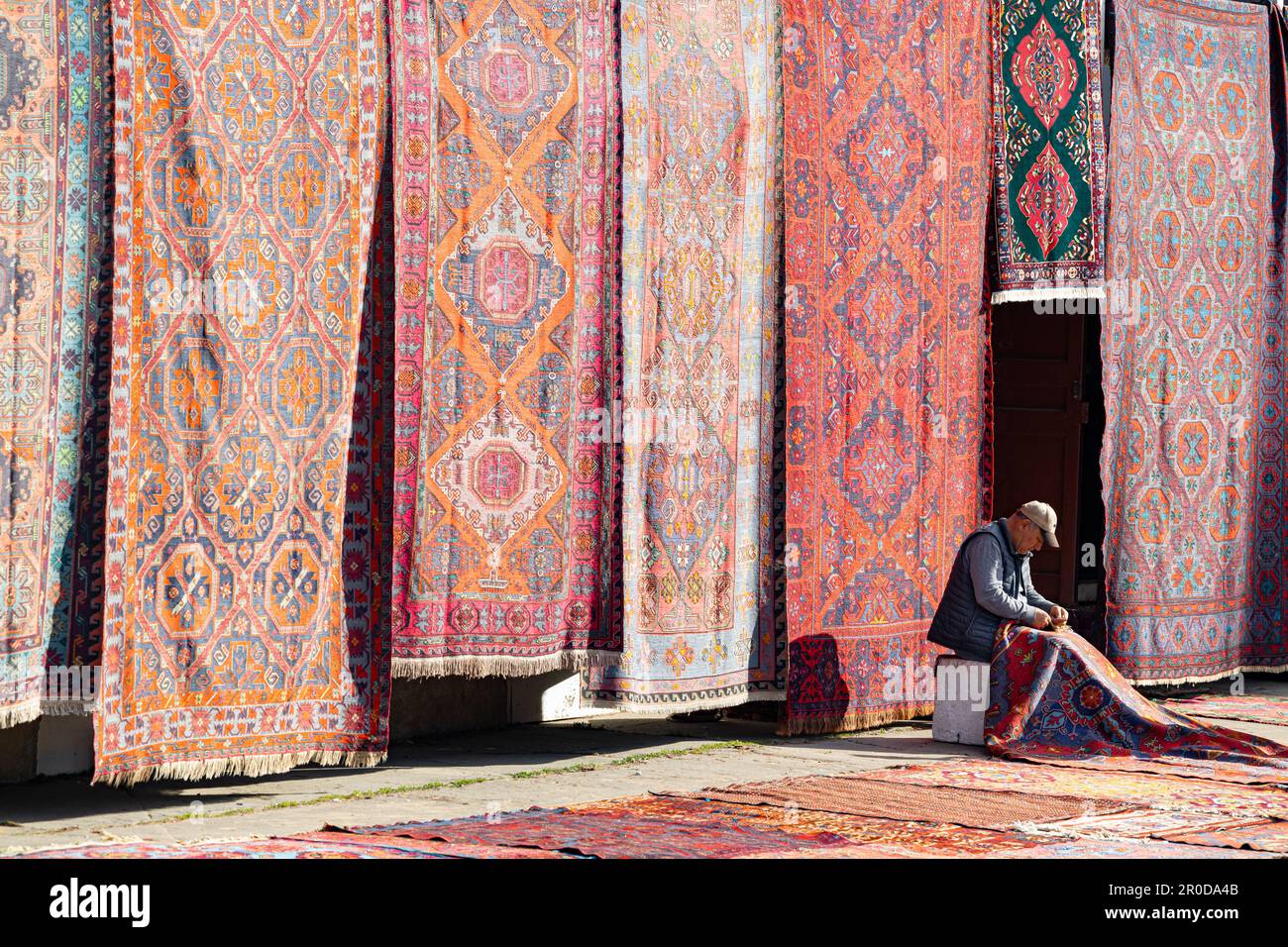 Moscow, Russia - April 22, 2023: oriental street market. man knitting ...