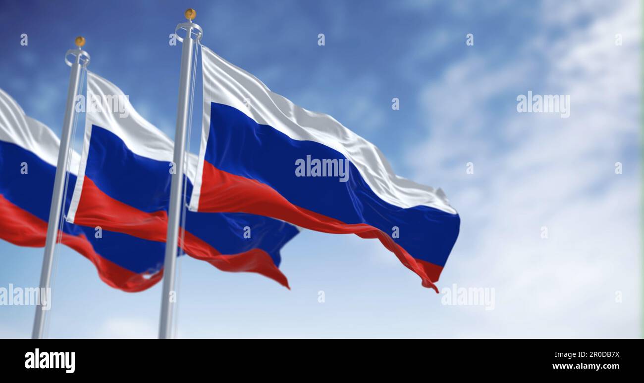 Three national flags of Russia waving in the wind on a clear day. White, blue and red horizontal ...