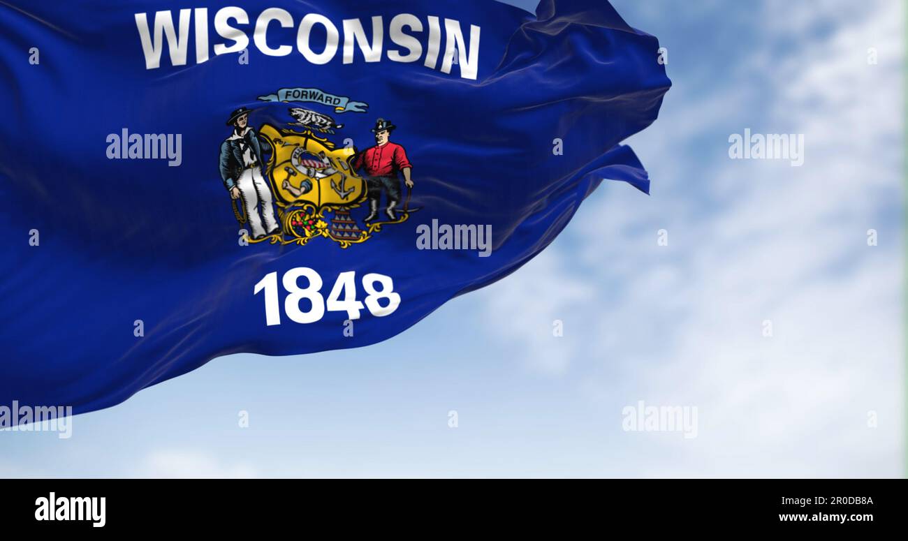 Wisconsin state flag waving on the wind on a clear day. Navy blue flag ...