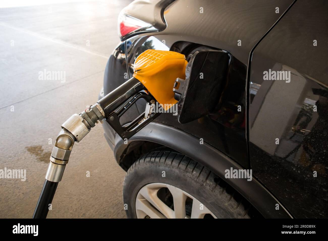 Fueling a car with a yellow pump,close up taken Stock Photo - Alamy