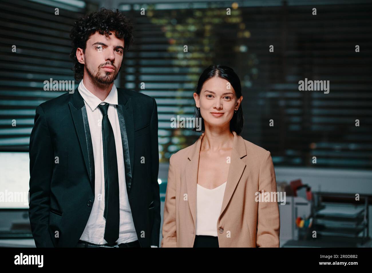 Portrait of successful business team standing in dark office after ...