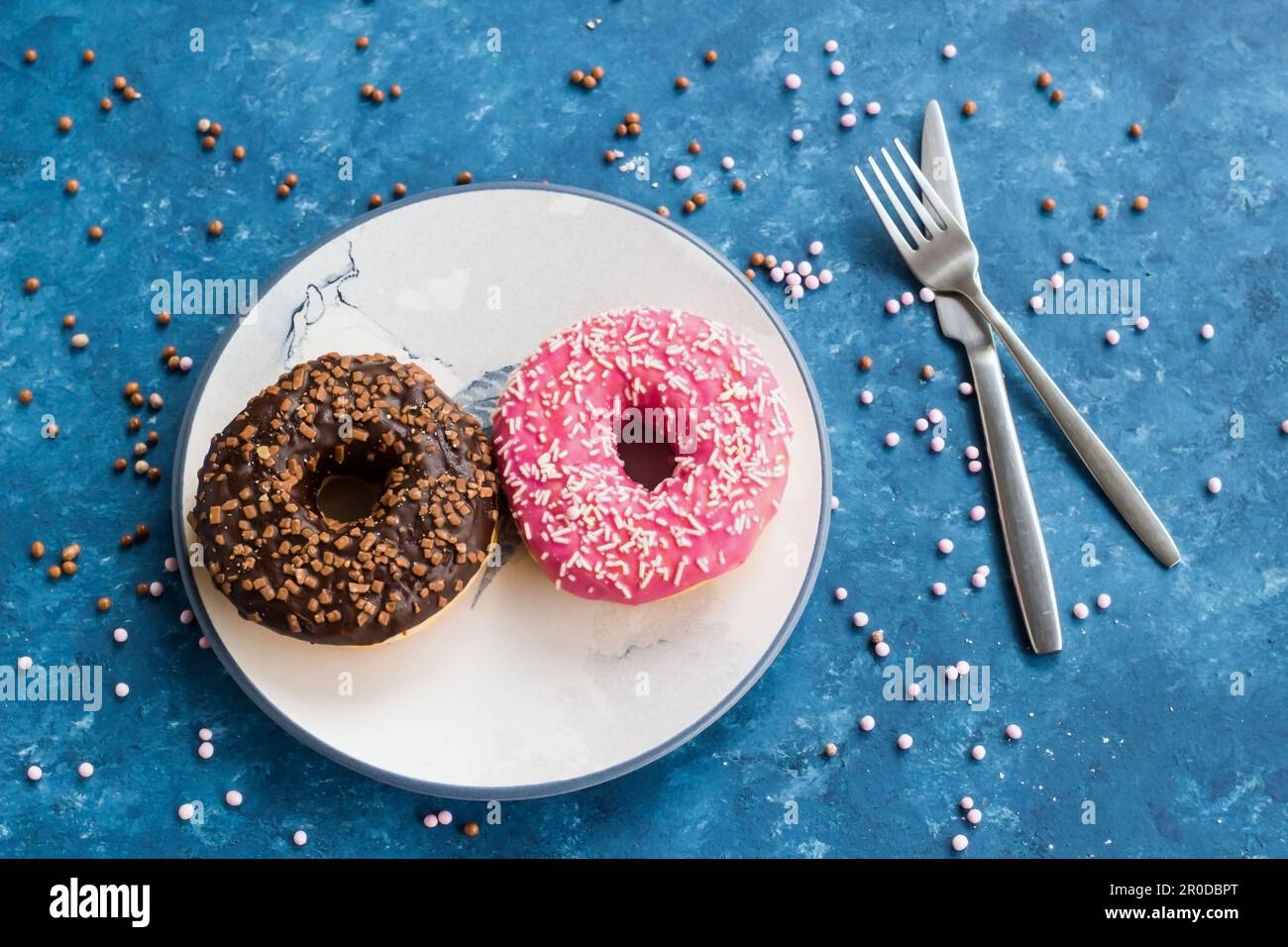Strawberry and chocolate donuts were designed on plates with decorative ...