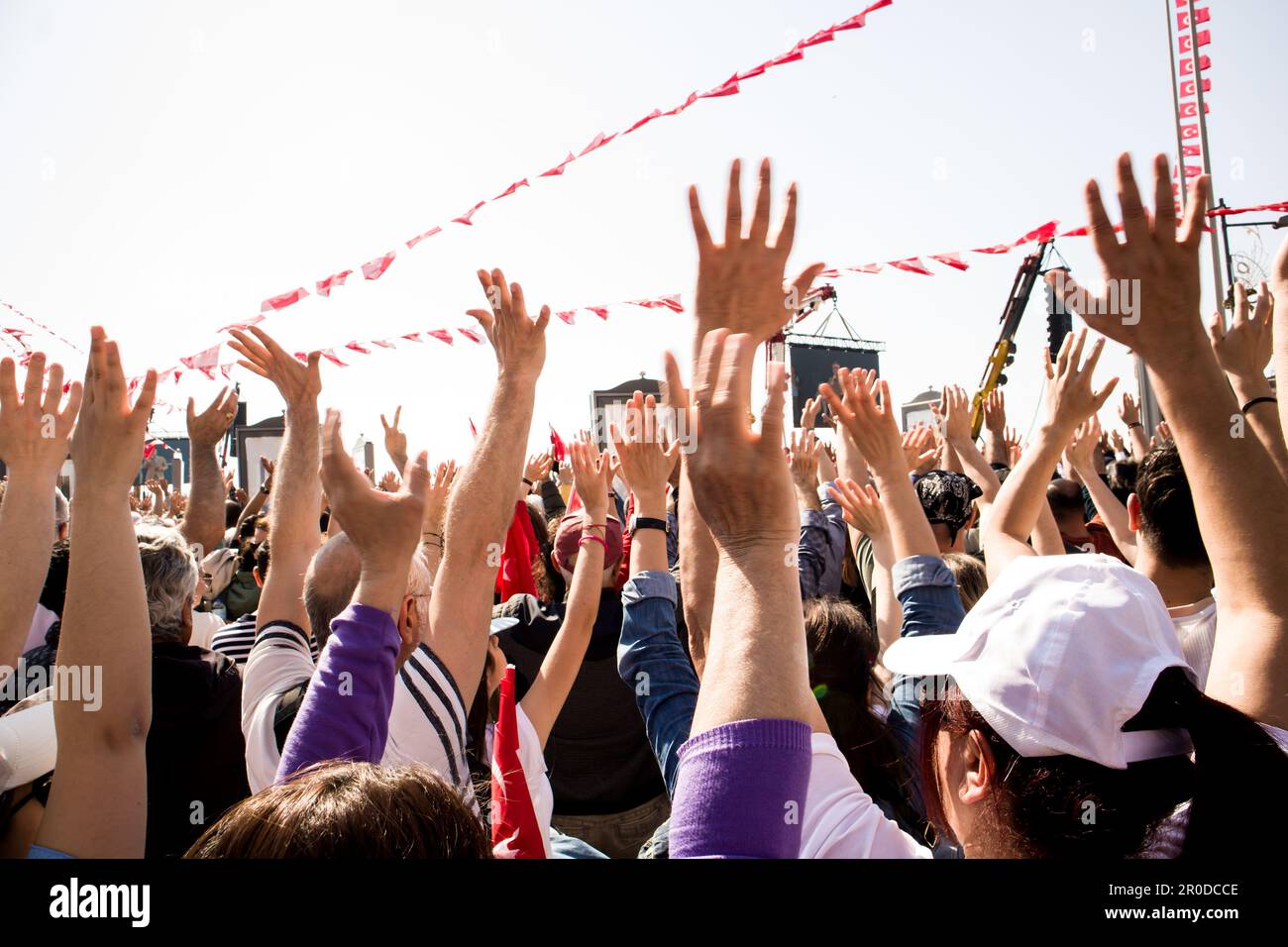 Unknown people, with their backs turned, hands up, at a celebration ...