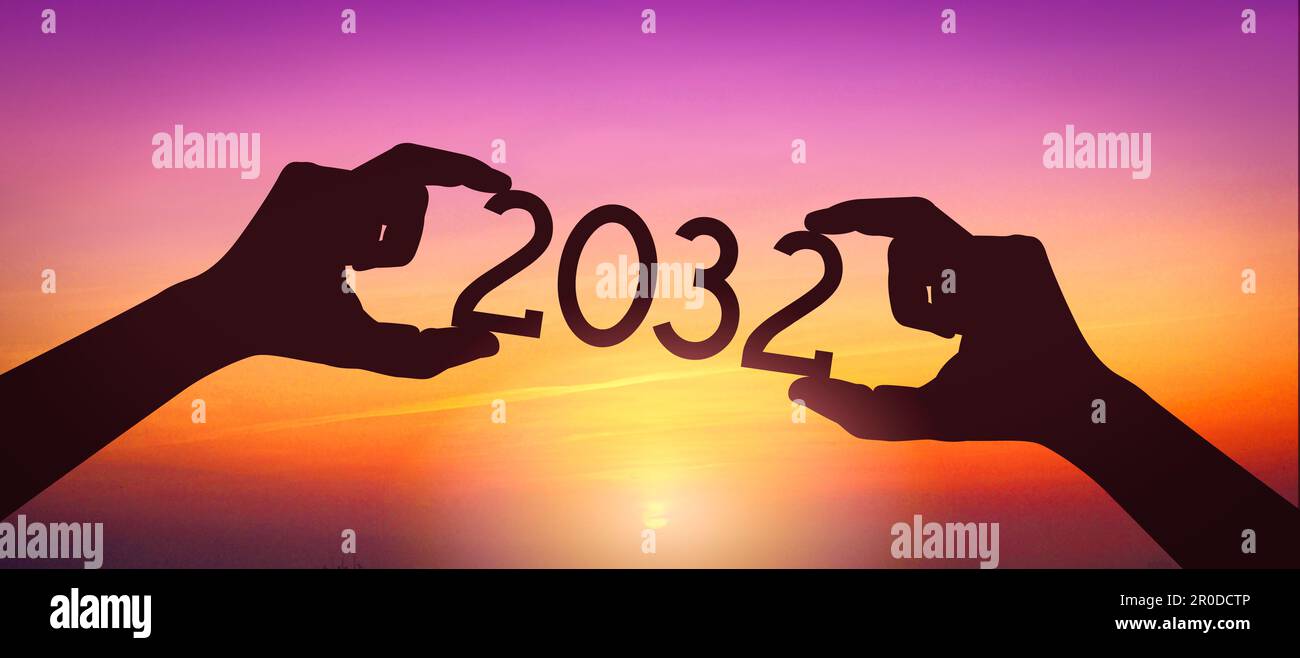 2032 - human hands holding black silhouette year number Stock Photo - Alamy