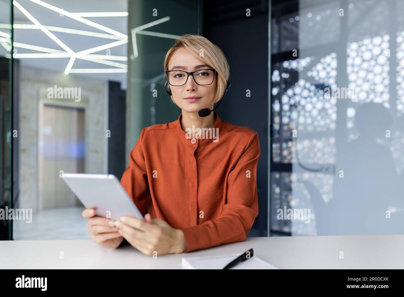 Portrait of confident female online customer support tech worker ...