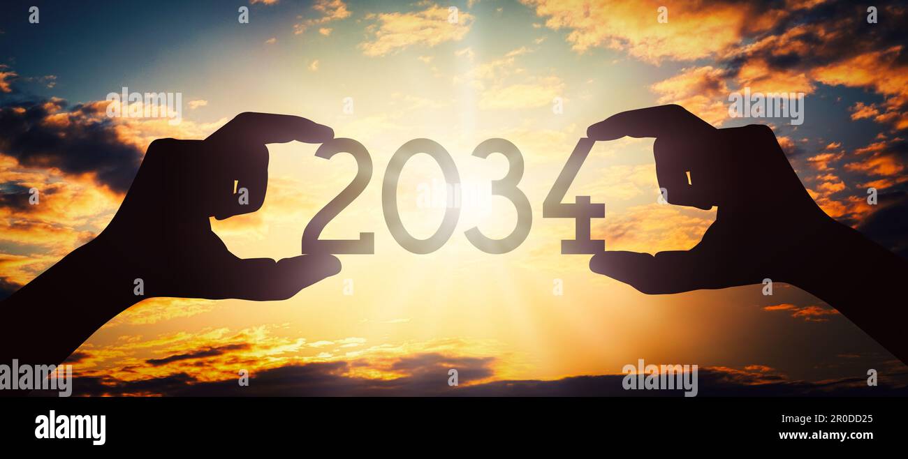 2034 - human hands holding black silhouette year number Stock Photo - Alamy