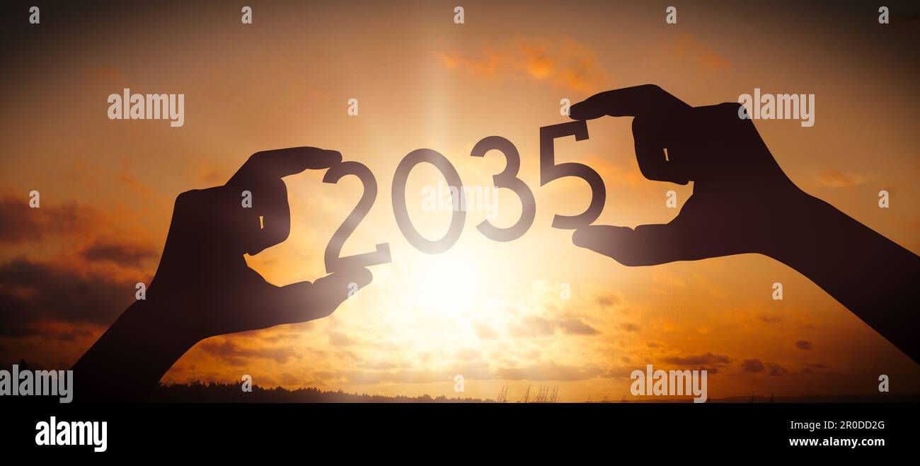 2035 - human hands holding black silhouette year number Stock Photo - Alamy