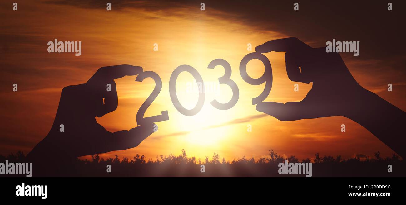2039 - human hands holding black silhouette year number Stock Photo - Alamy