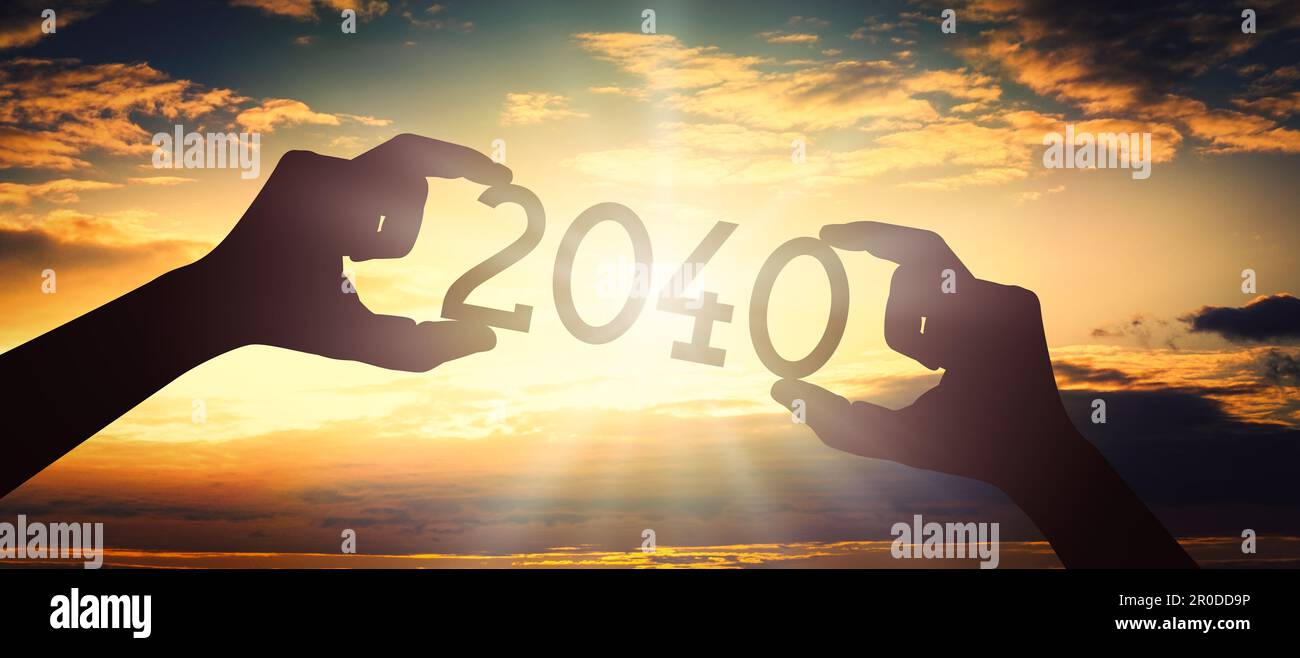 2040 - human hands holding black silhouette year number Stock Photo - Alamy