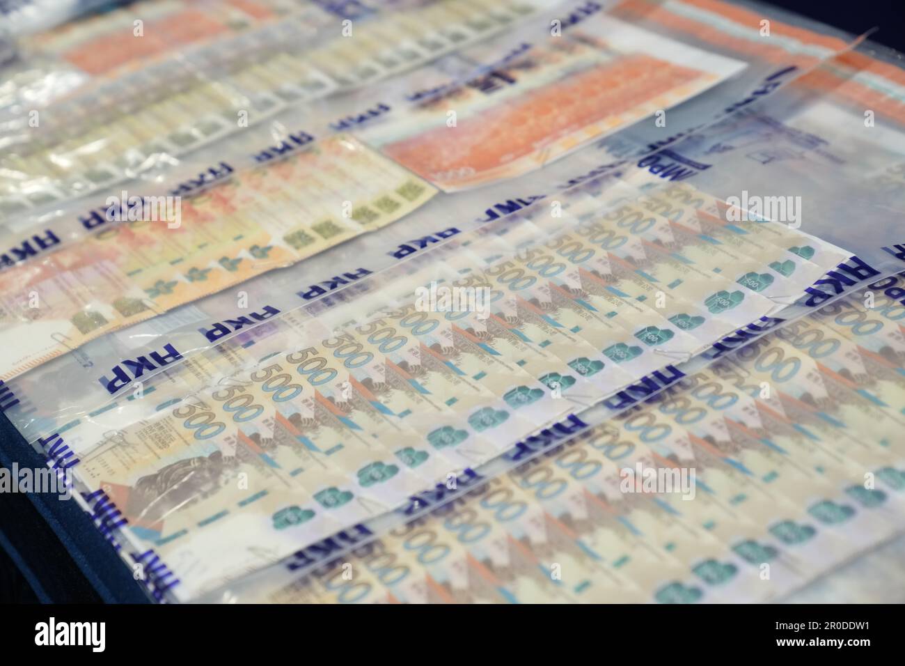 Seized items, including banknotes, smart phones and SIM cards which ...