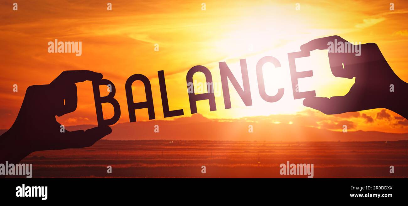 Balance - human hands holding black silhouette word Stock Photo - Alamy