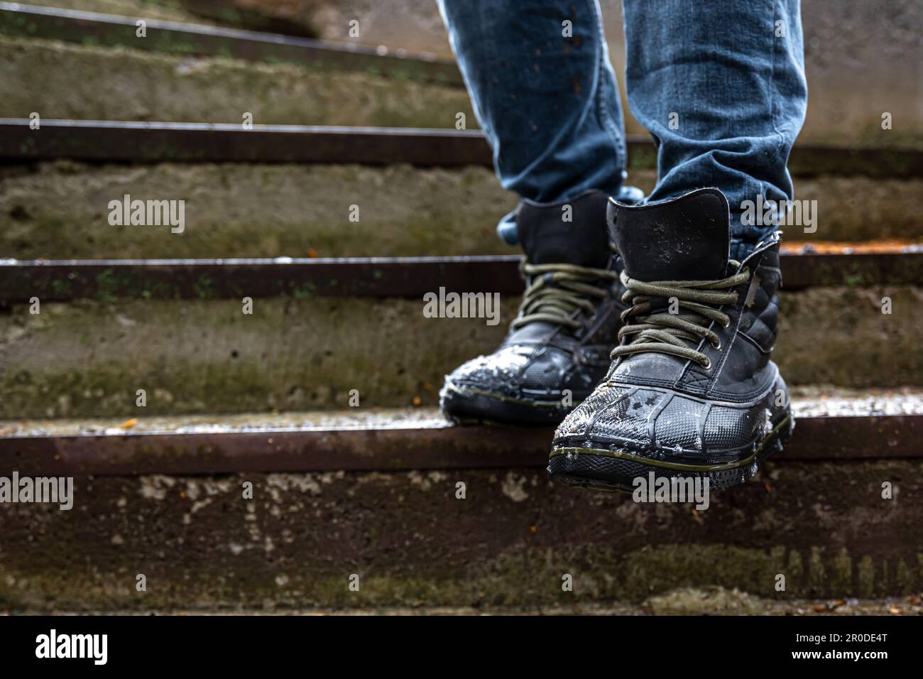 A man in boots on the old steps, close-up Stock Photo - Alamy