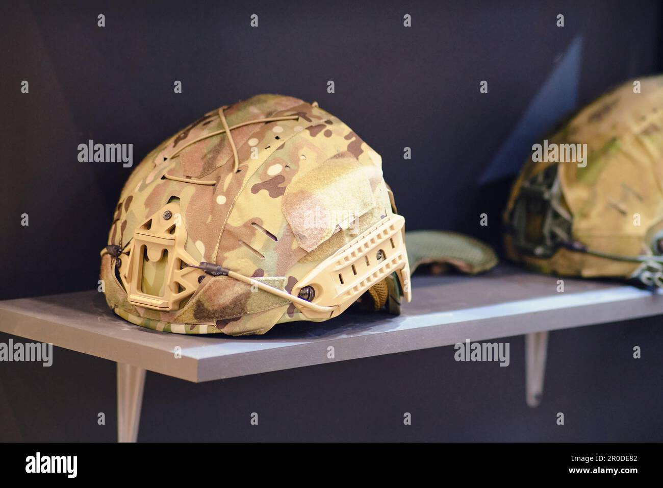 The soldier's helmet, part of the khaki military uniform, is present in ...