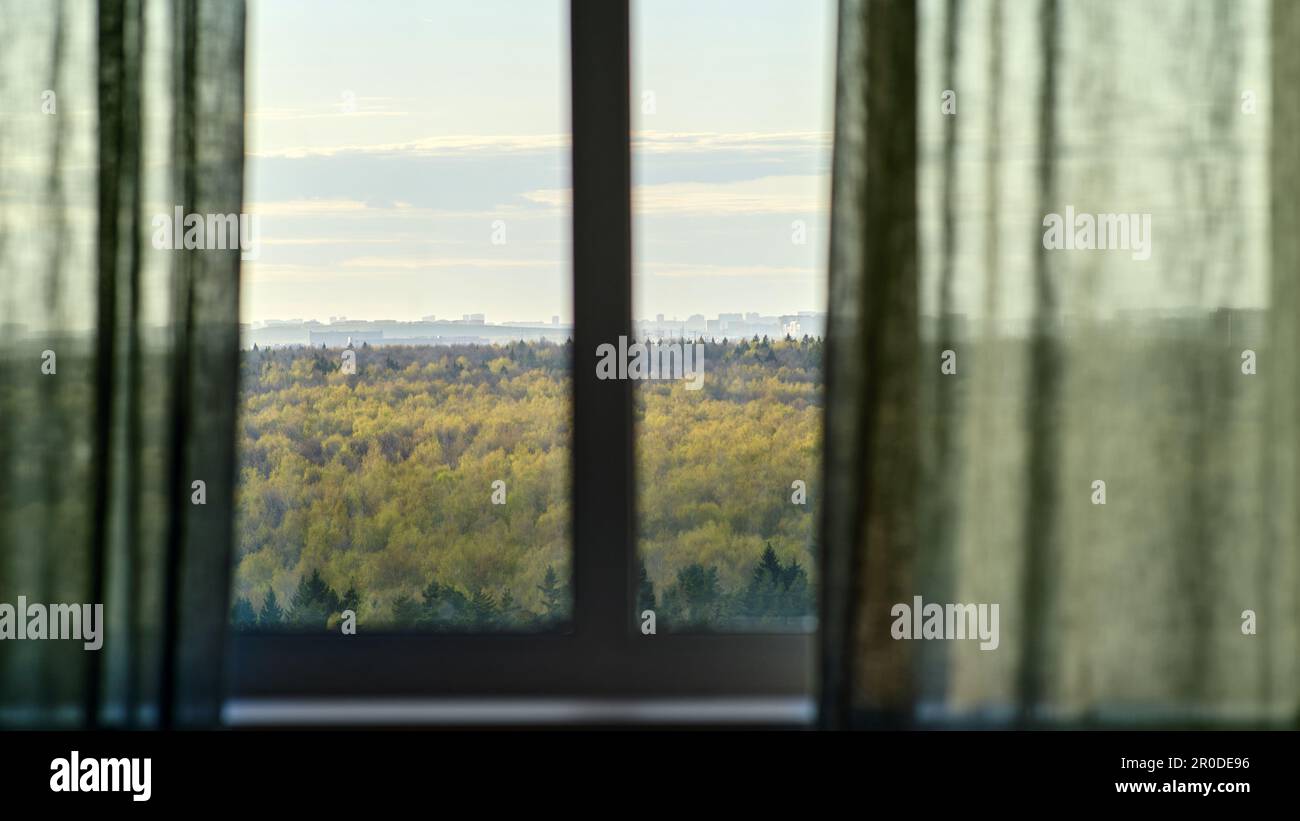 Window with curtains, window sill and clouds floating behind the glass ...