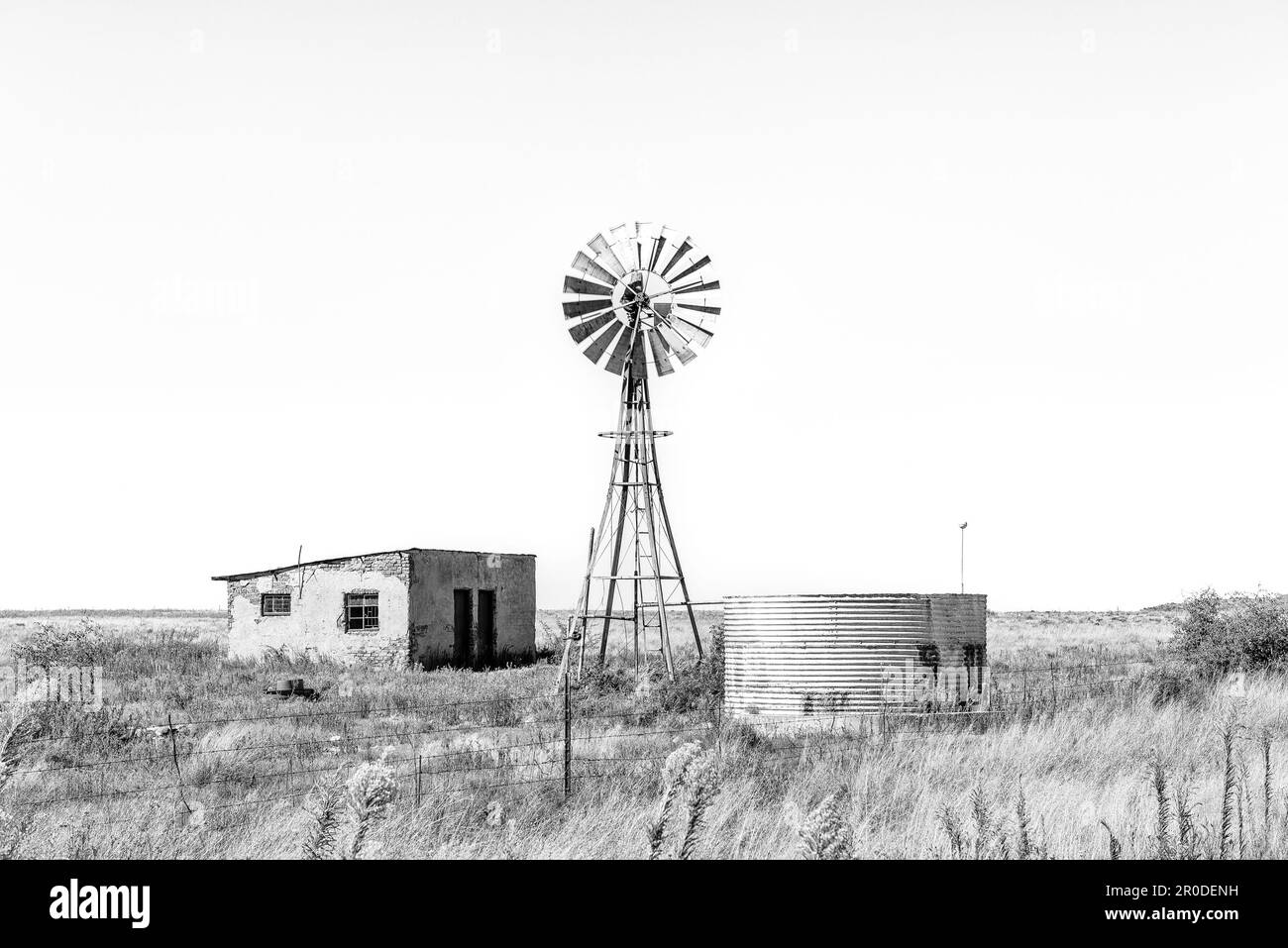 An abandoned farm worker house, windmill and dam next to road S129 ...