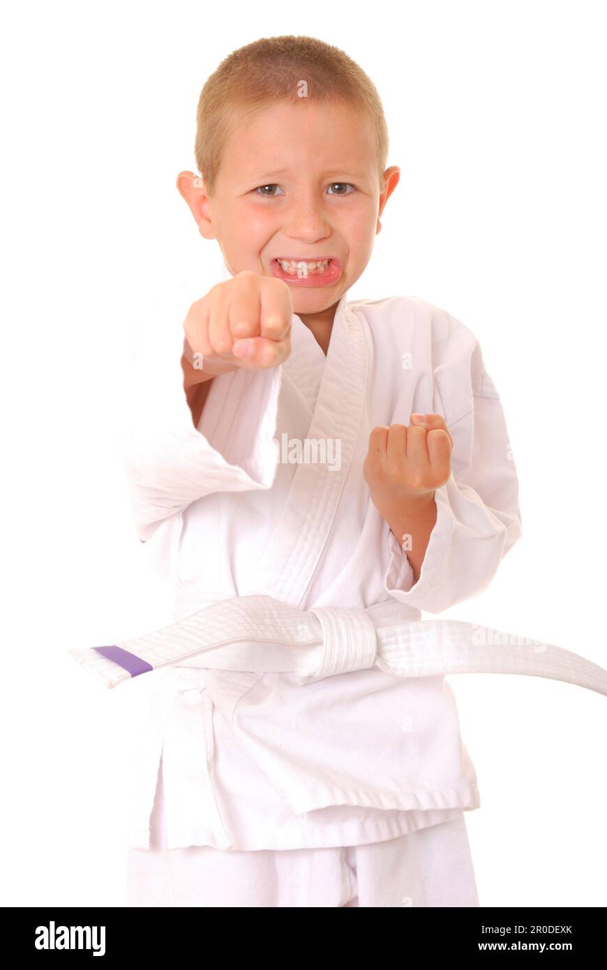 Young boy practicing karate isolated on white Stock Photo - Alamy