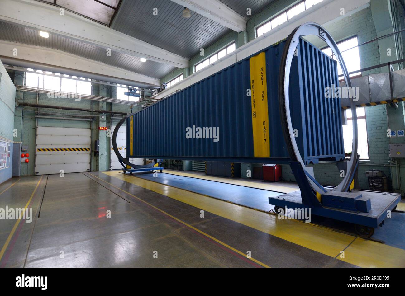 Cargo container set in a frame of rotating machine for repairing ...