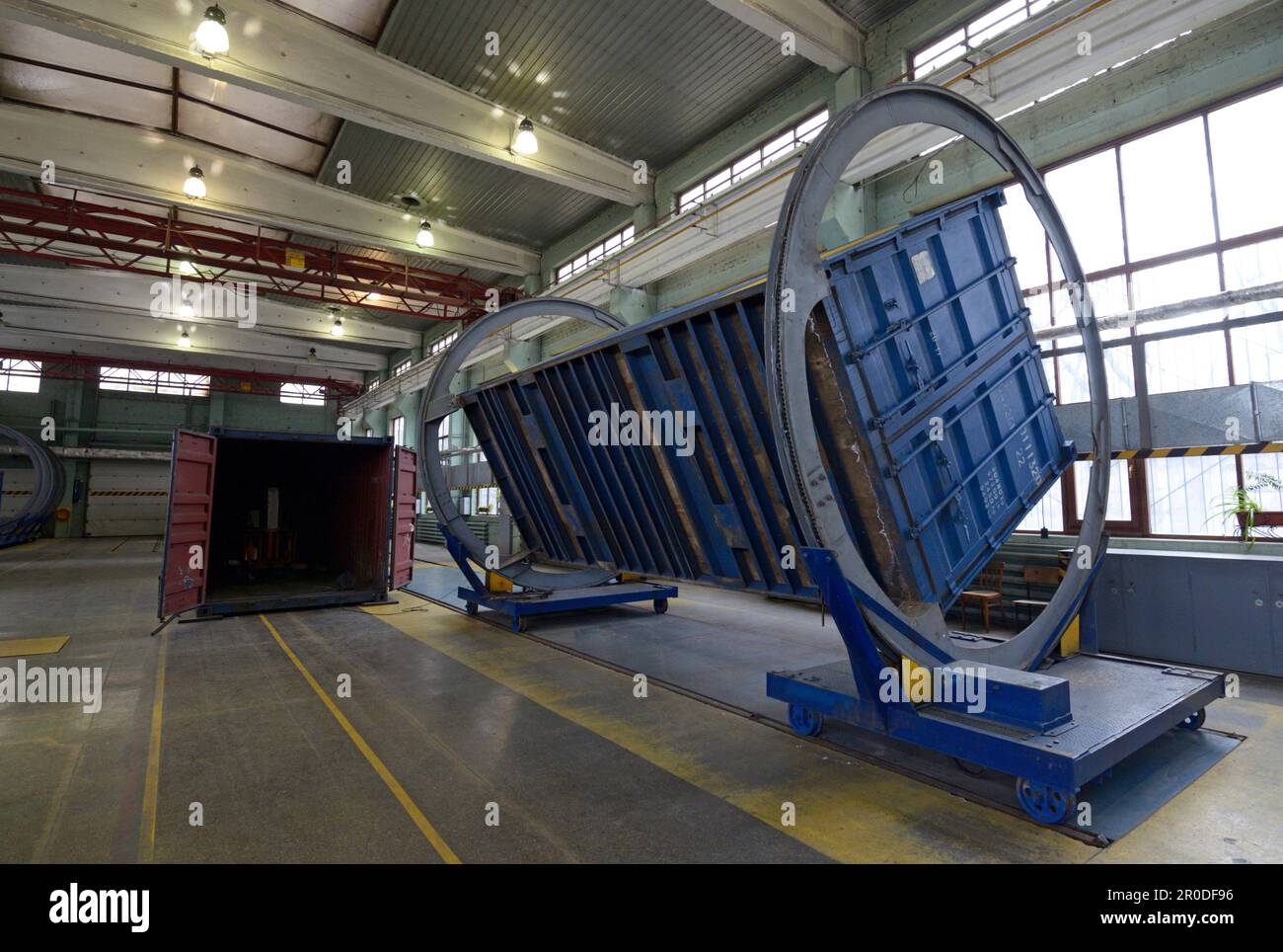 Cargo container set in a frame of rotating machine for repairing ...