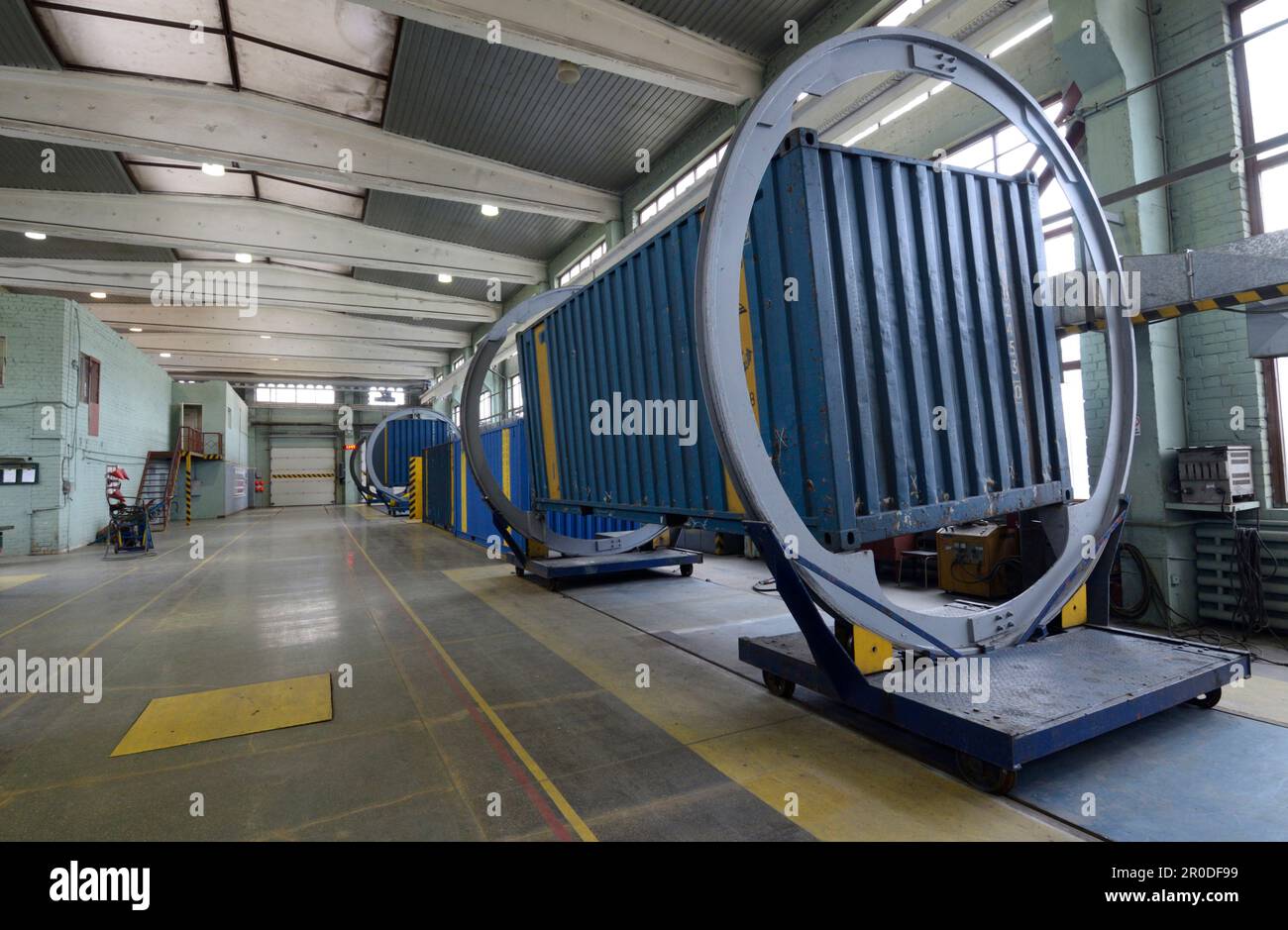 Cargo container set in a frame of rotating machine for repairing ...