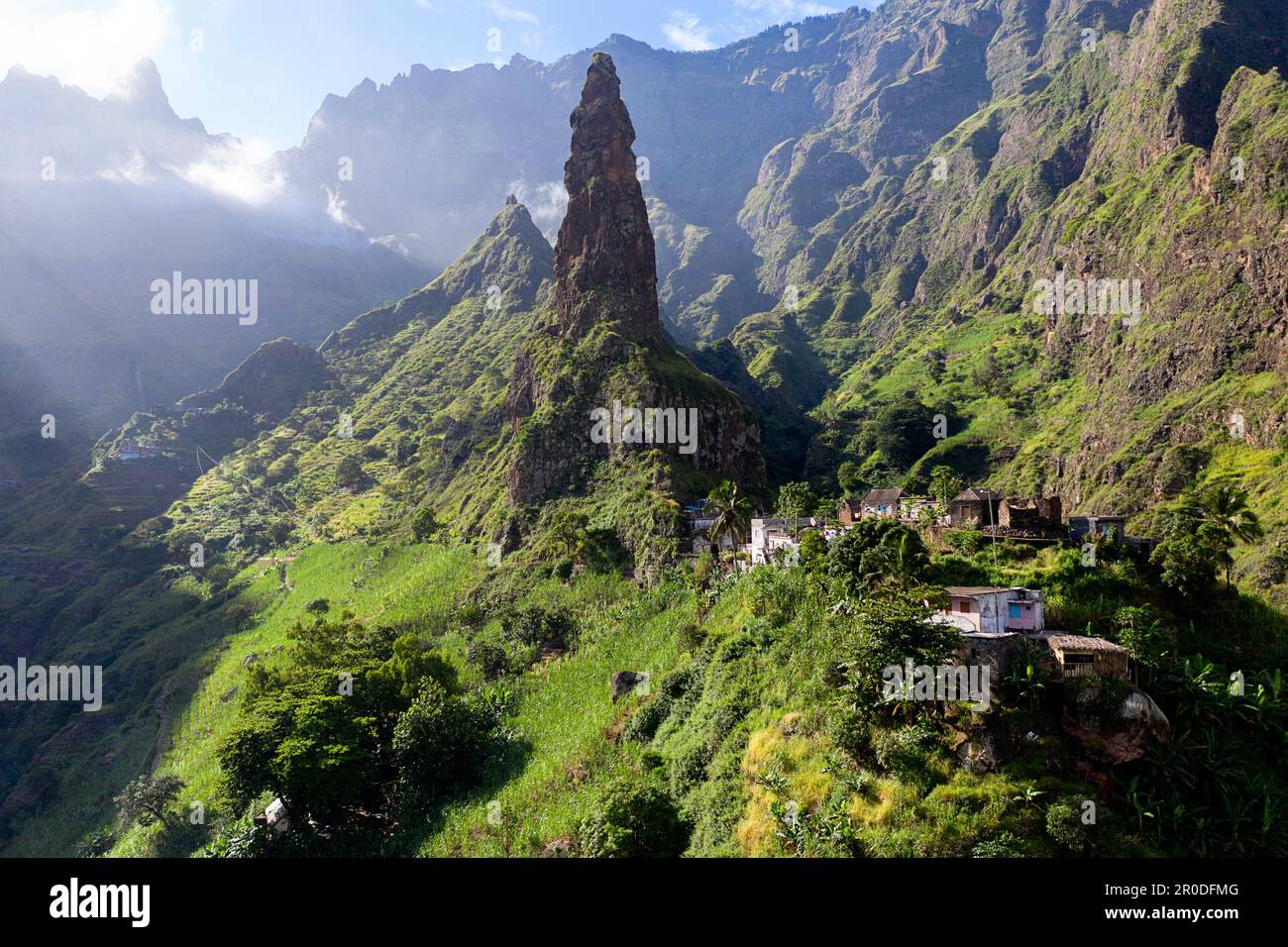 Aerial view of a valley with small village under big monolith, surrounded with spectacular ...