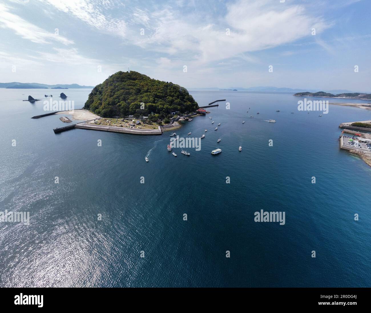 An aerial view of a small island covered with greenery in Japan on a ...
