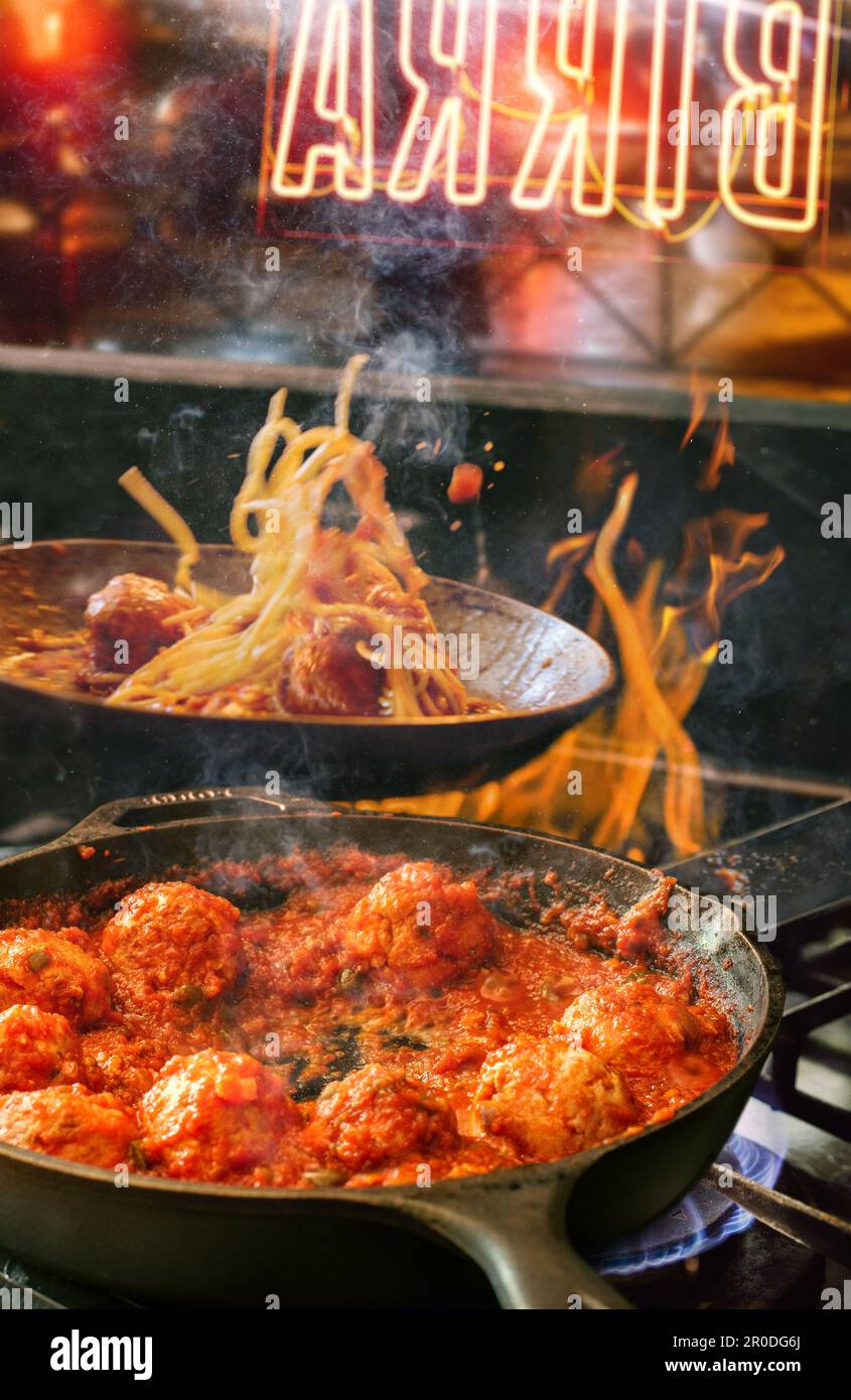 Kitchen in a traditional Italian trattoria cooking Spaghetti and ...