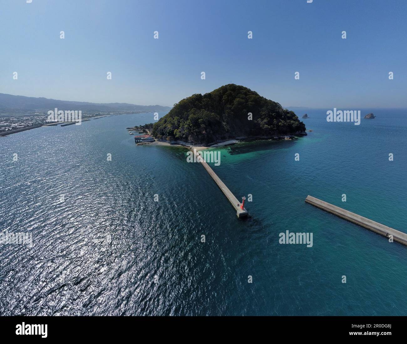 An aerial view of a small island covered with greenery in Japan on a ...