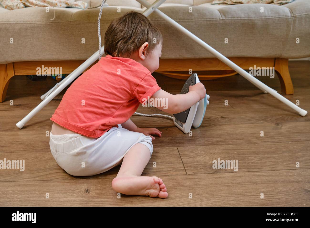 Playing with a hot iron is dangerous for a baby, as it can cause severe ...