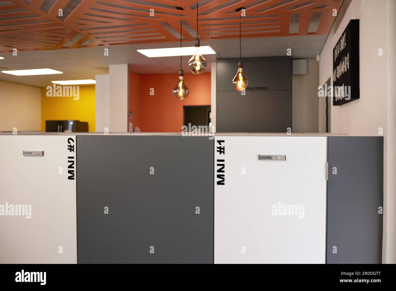 Empty modern office space with row of private cubicles and offices ...