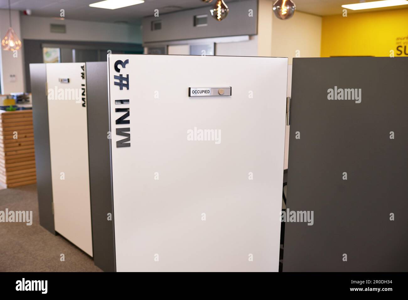 Empty modern office space with row of private cubicles and offices ...