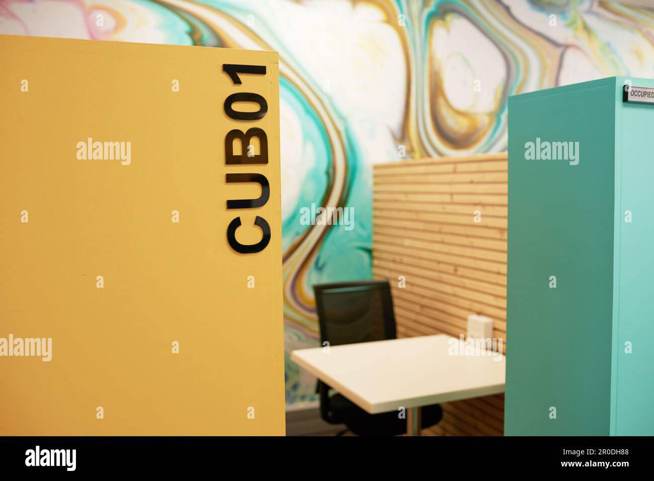 Empty private cubicle in a modern office, colourful and bright, desk ...