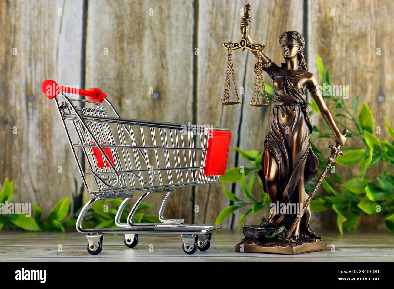Shopping trolley and symbol of law and justice. Consumer rights concept ...