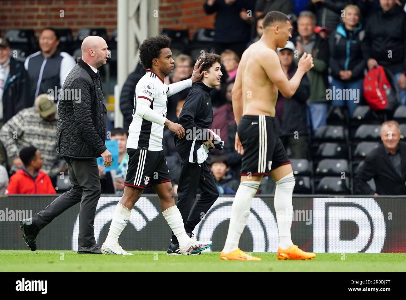 A pitch invader with Fulham's Willian following the Premier League ...