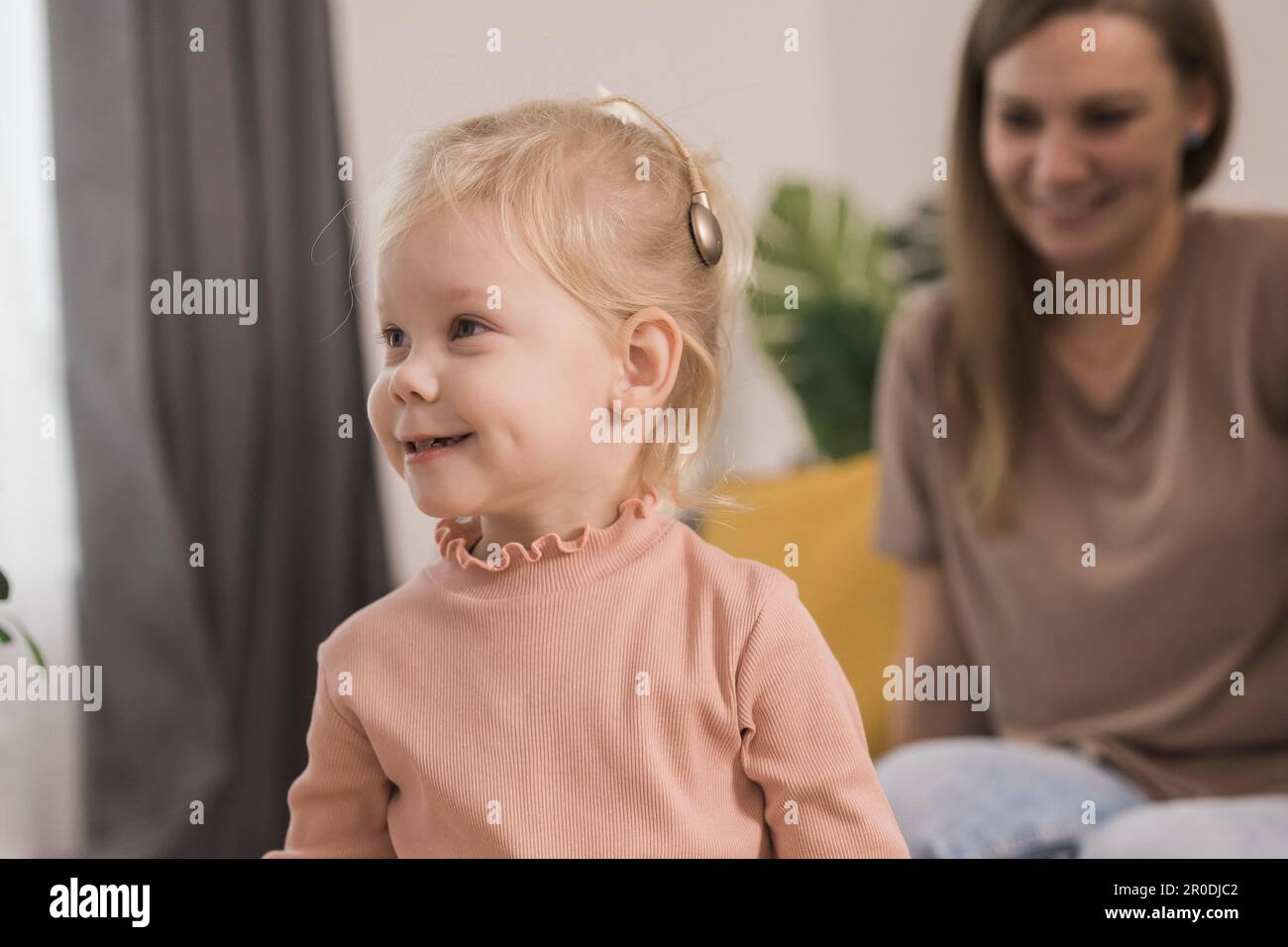 Deaf kid with hearing aid cochlear implant have fun with parents - Hear ...