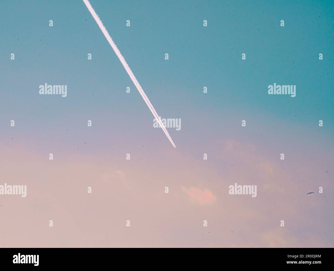 plane flying in the sky and releasing smoke Stock Photo - Alamy