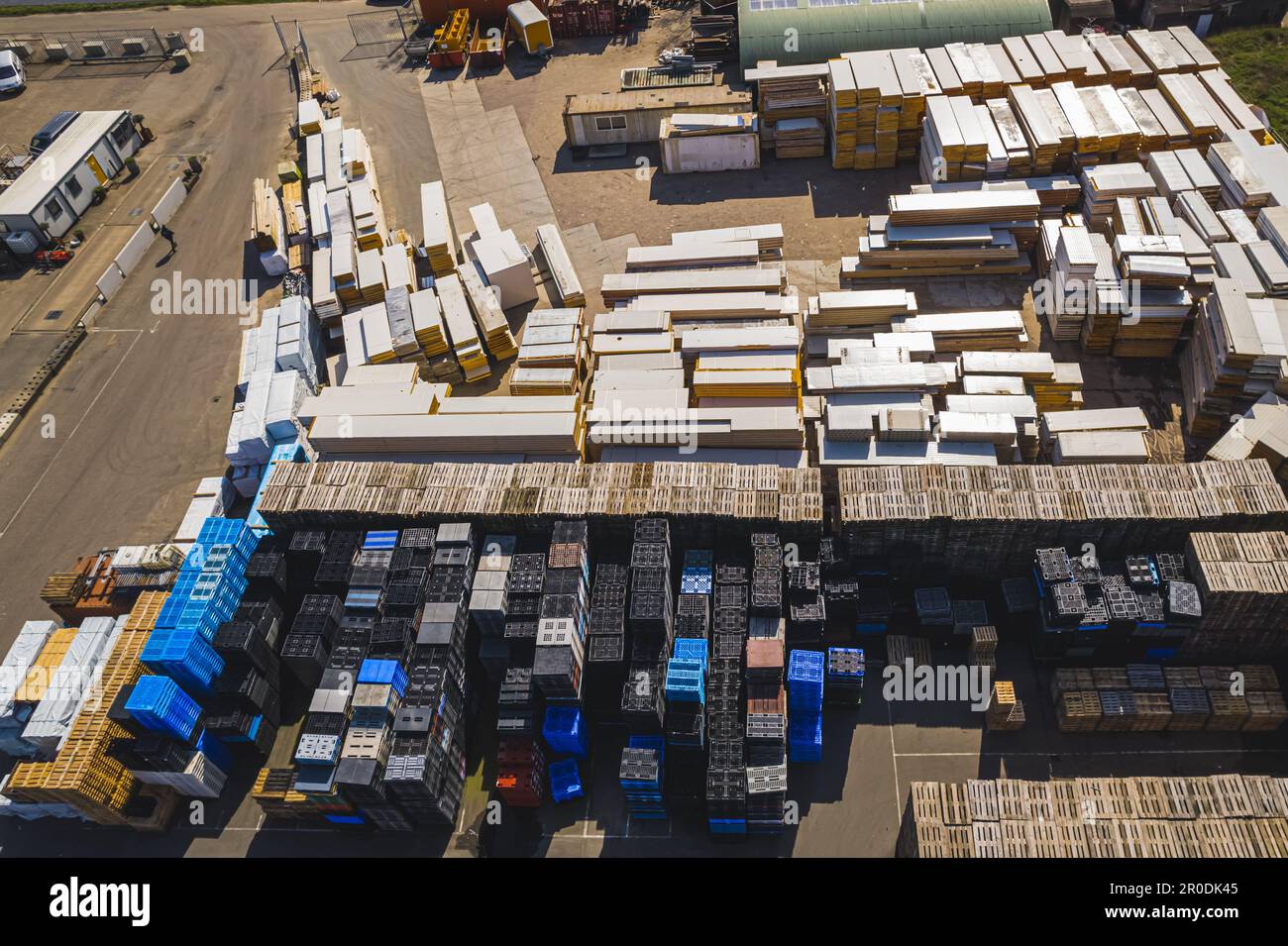 Top drone view over large stacks of wooden pallets for transporting ...