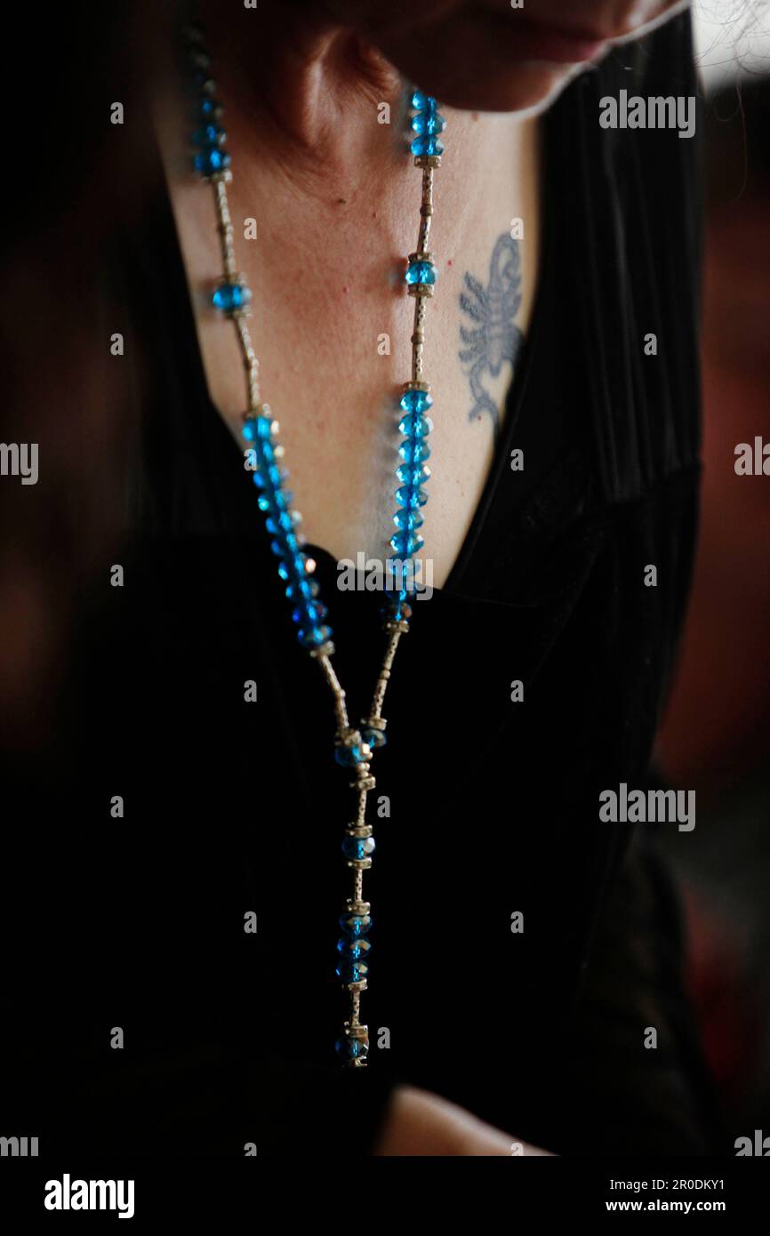 Maria Mosqueda wears her rosary as she makes tostadas at the Mosqueda ...
