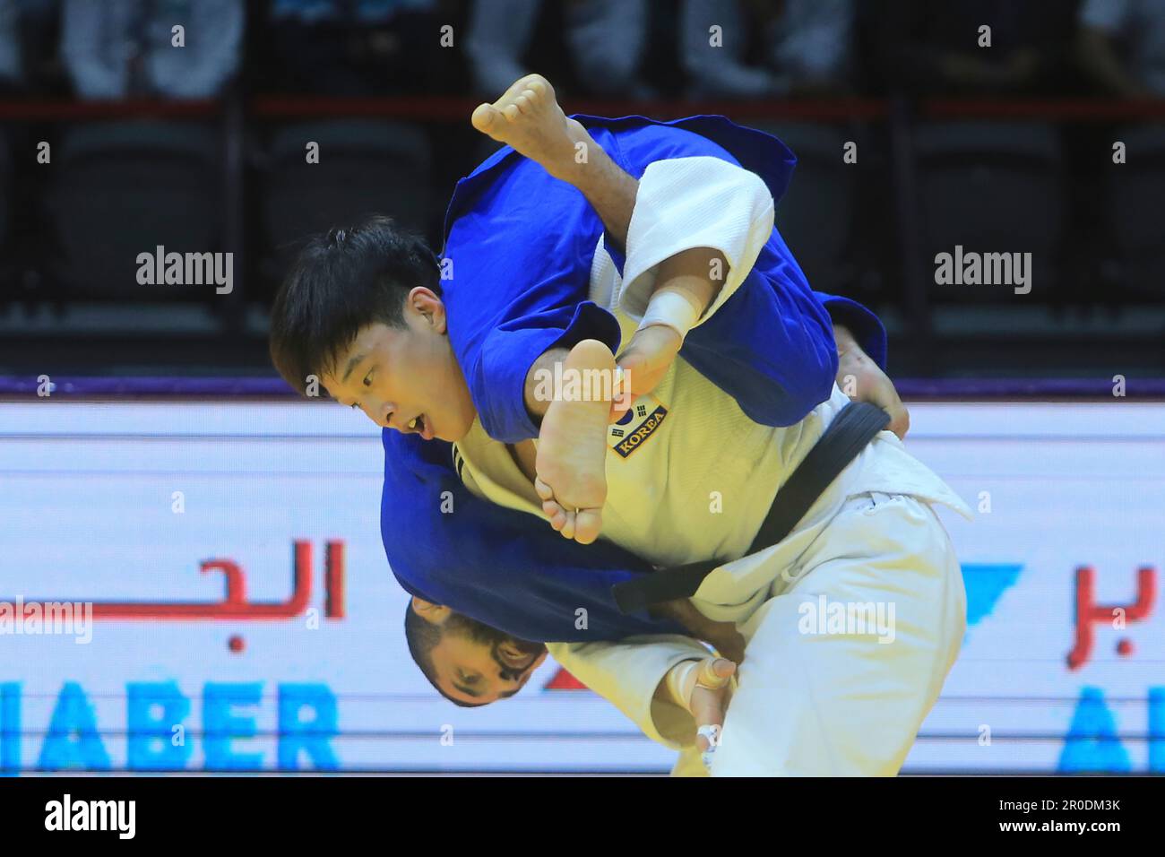 Walide Khyar of France, background, and Baul An of South Korea compete ...