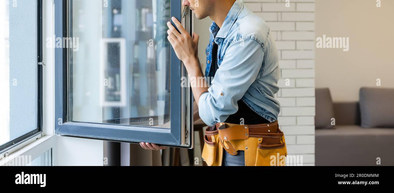 Construction Worker Installing New Windows In House Stock Photo - Alamy
