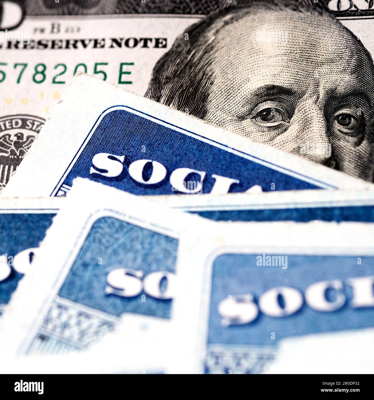 Several Social Security Cards on a US United States one hundred dollar ...