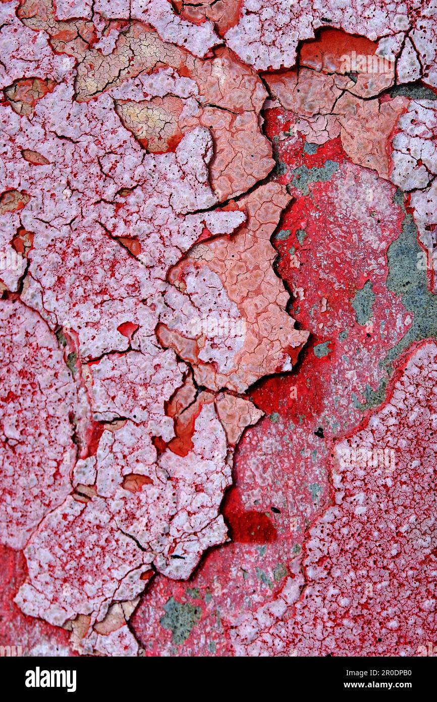 Red textured pealing paint that is cracked and weathered on painted ...