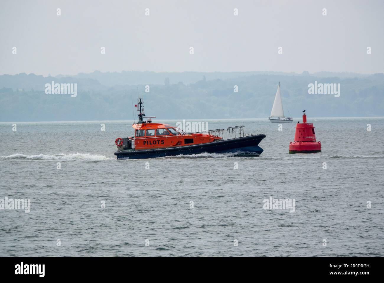 A pilot Boat at see guiding a ship into port Stock Photo - Alamy