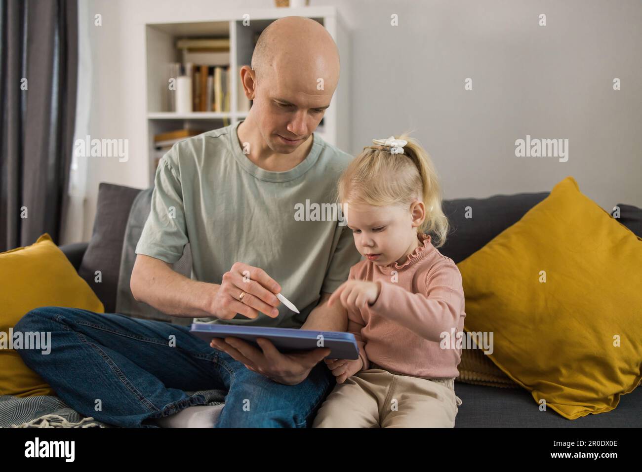 People with cochlear implant system. Kid study to hear with her father ...