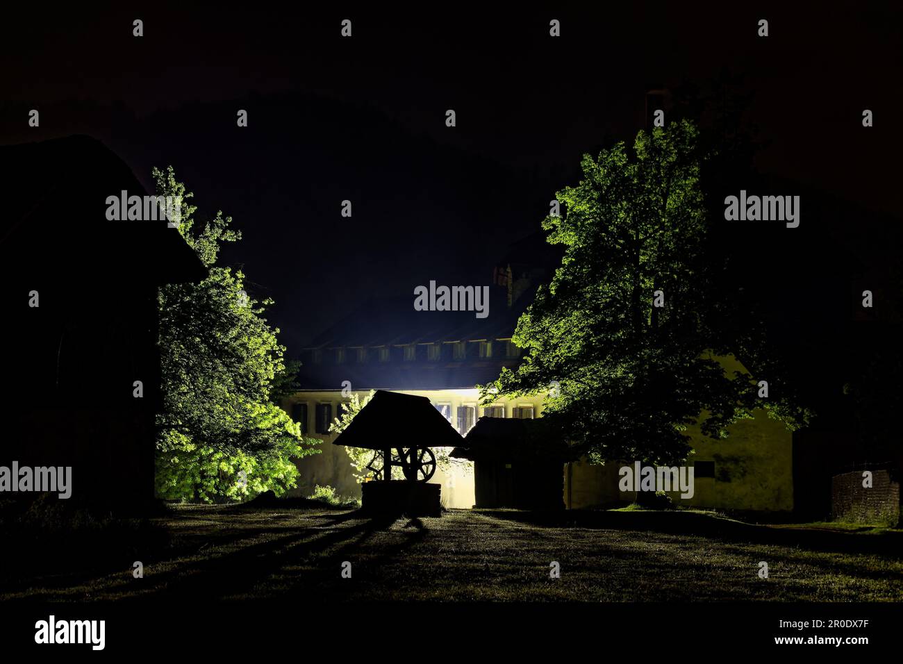 A silhouette of a water well near buildings Stock Photo - Alamy