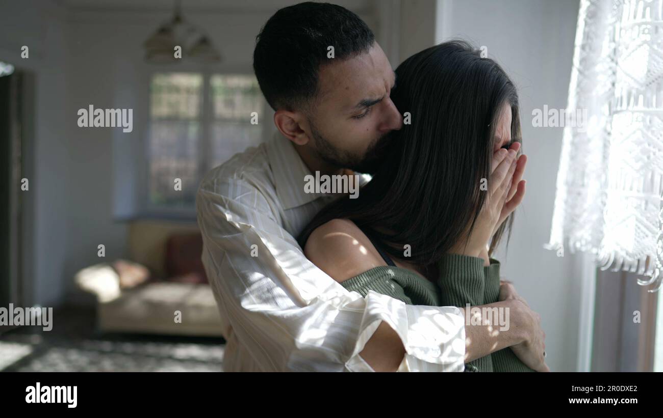 An Arab boyfriend reaching out to depressed girlfriend standing by ...