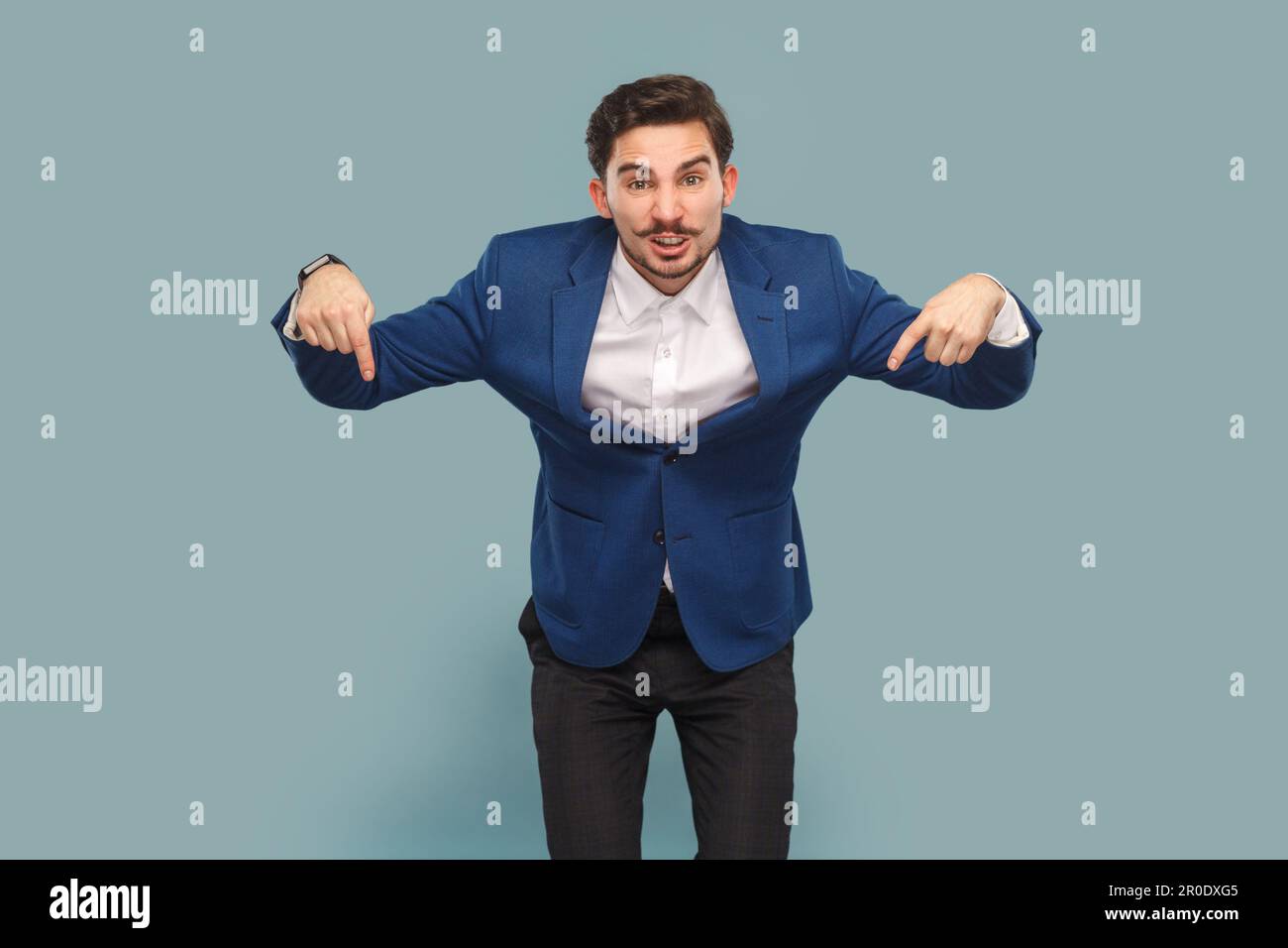 Angry man with mustache standing pointing down, giving command, looking ...