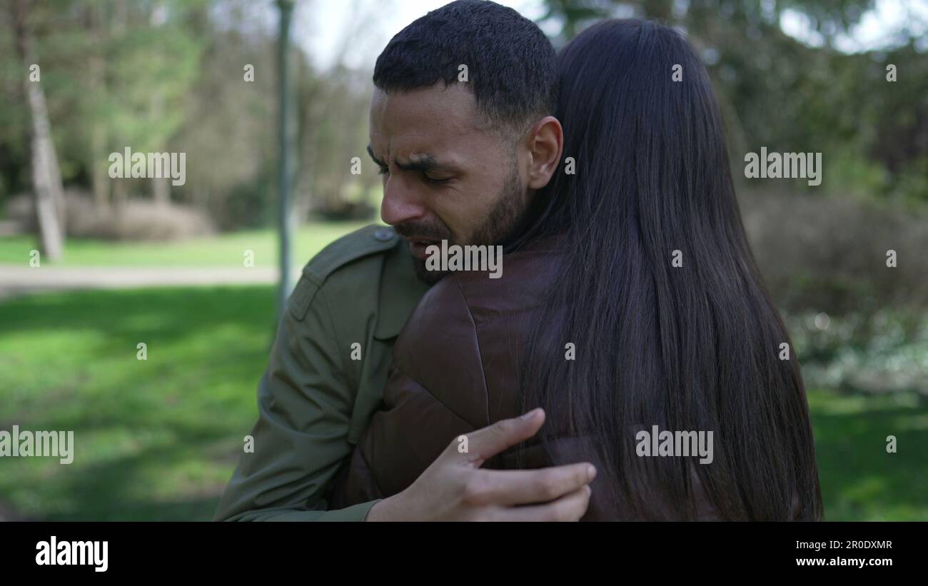 Girlfriend consoling sad depressed man standing outside. Woman having ...