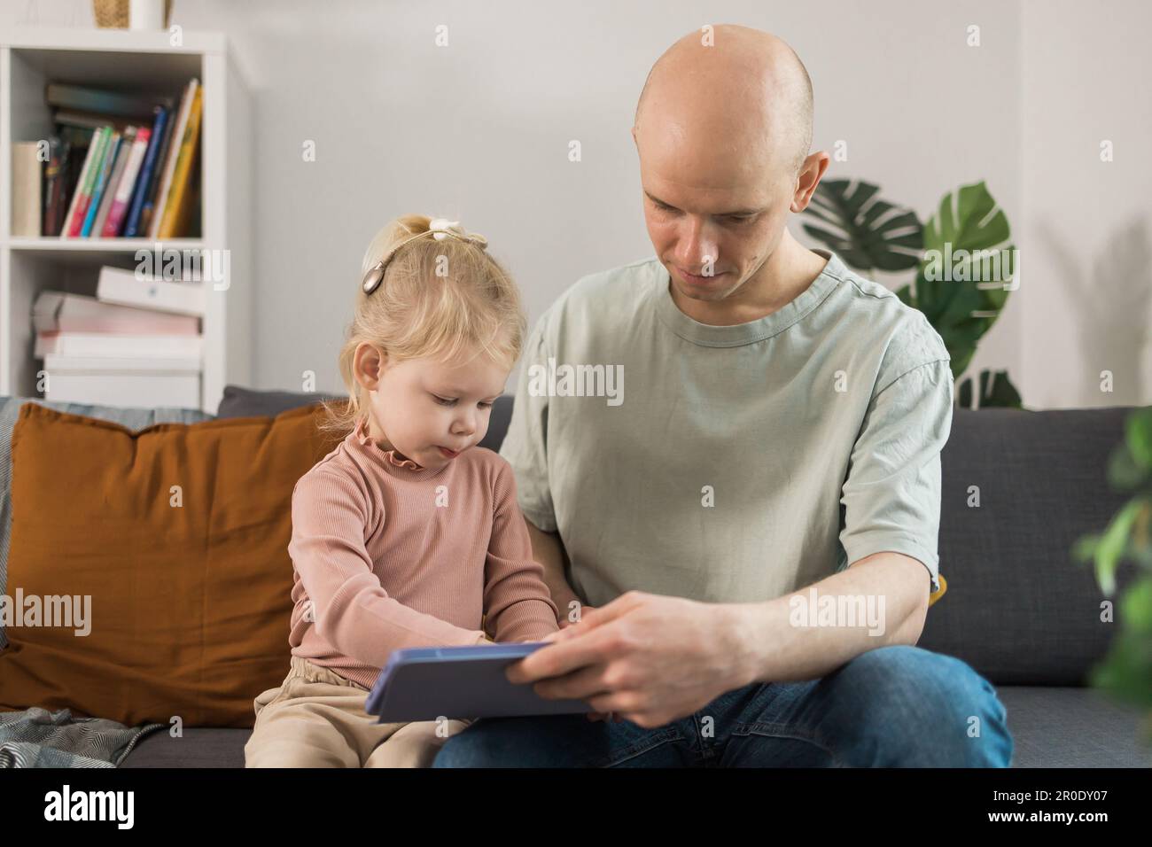 People with cochlear implant system. Kid study to hear with her father ...