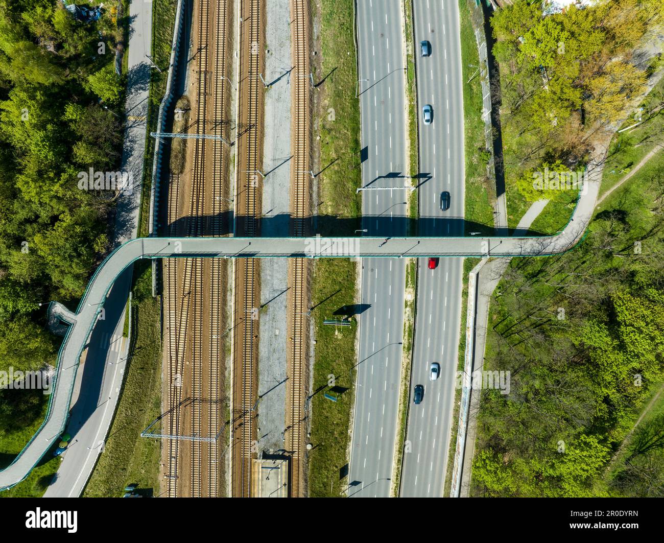 Footbridge and cycle path joining two public parks over railroad tracks ...
